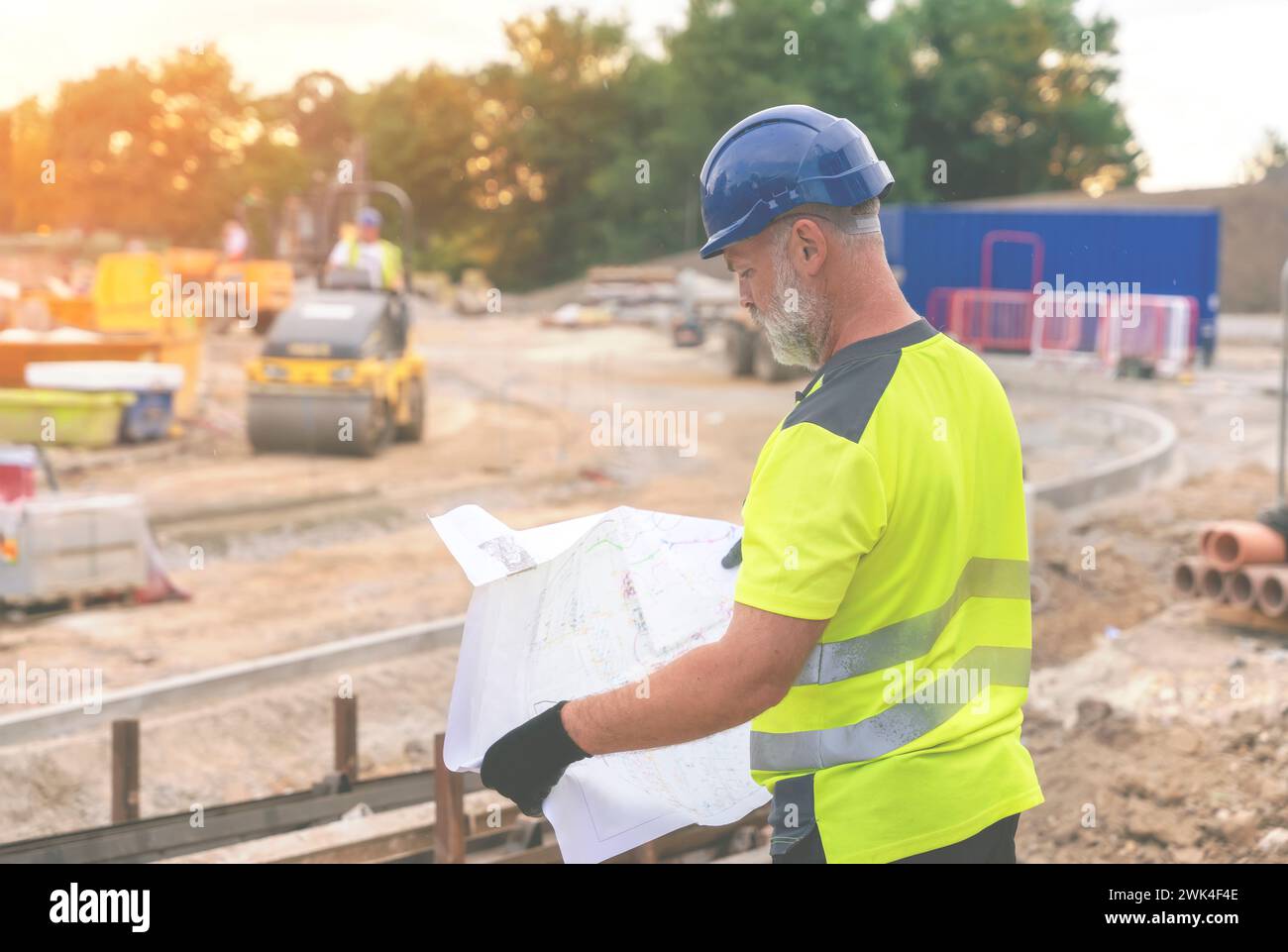 A builder site engineer surveyor working with theodolite total station EDM equipment on a ...