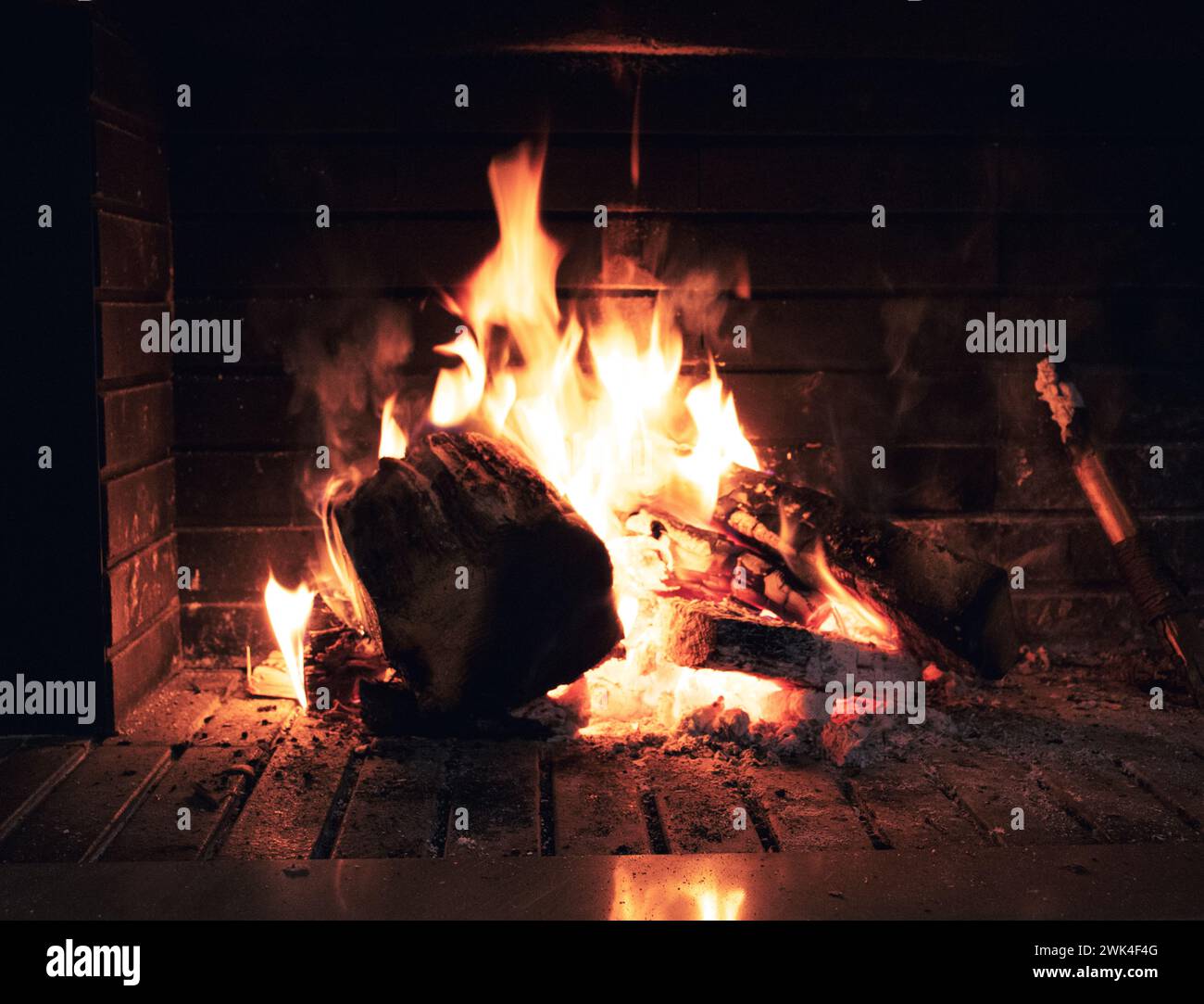 Burning firewood of fireplace in cottage photo. Rustic fire-box with ...