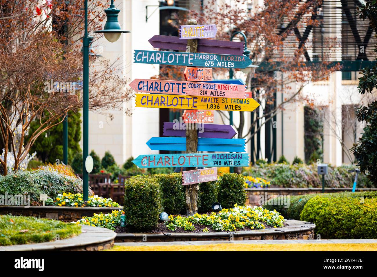 Colorful directions signs in Charlotte The Green city center park at ...