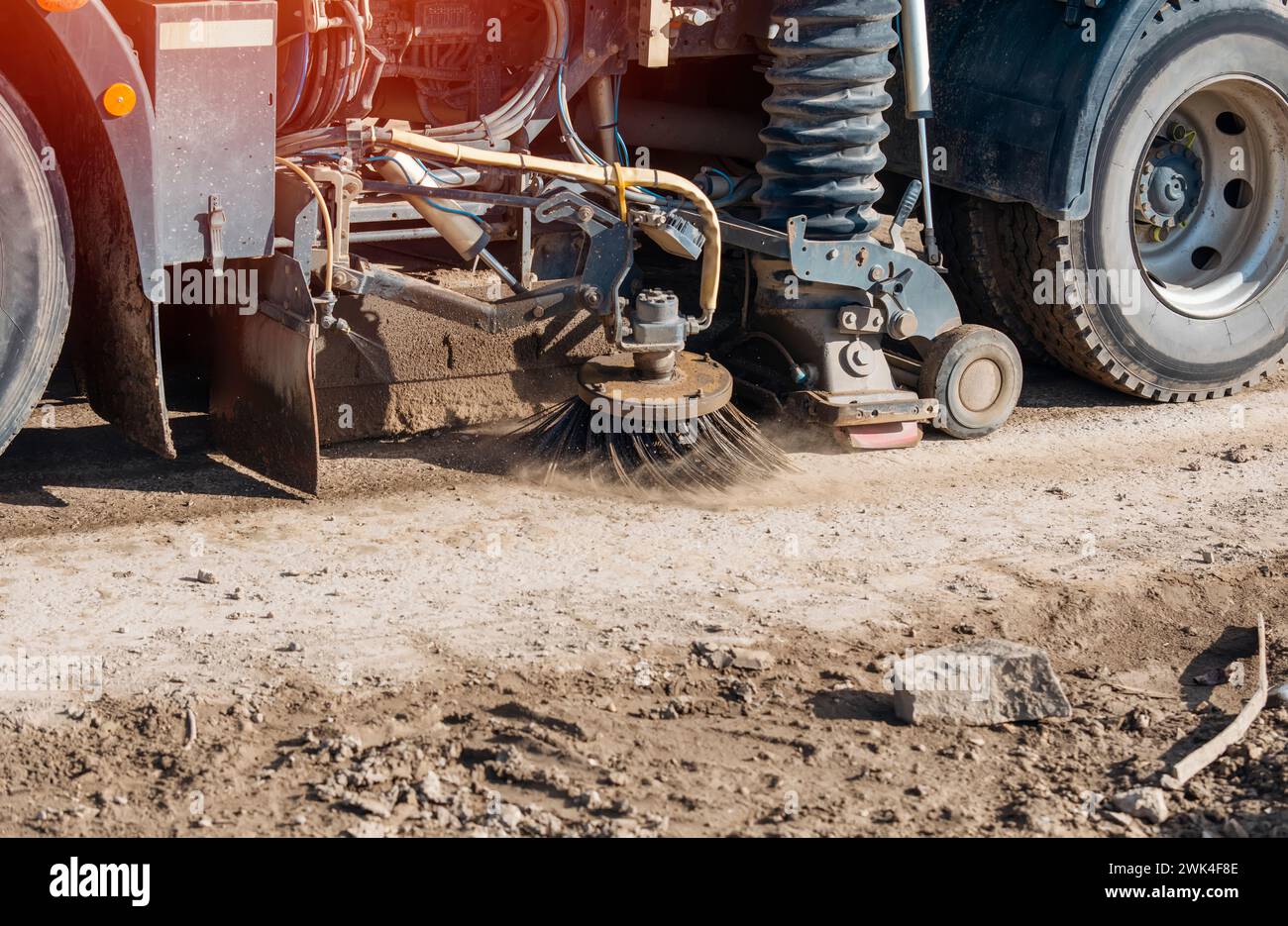 Road sweeper cleaning road next to a construction site Stock Photo - Alamy
