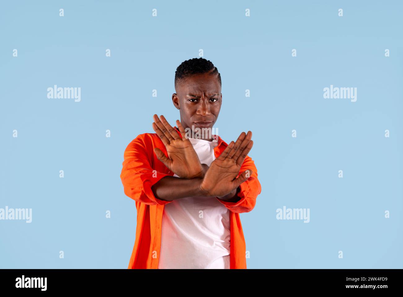 woman in orange shirt crossing hands in refusal negative expression ...