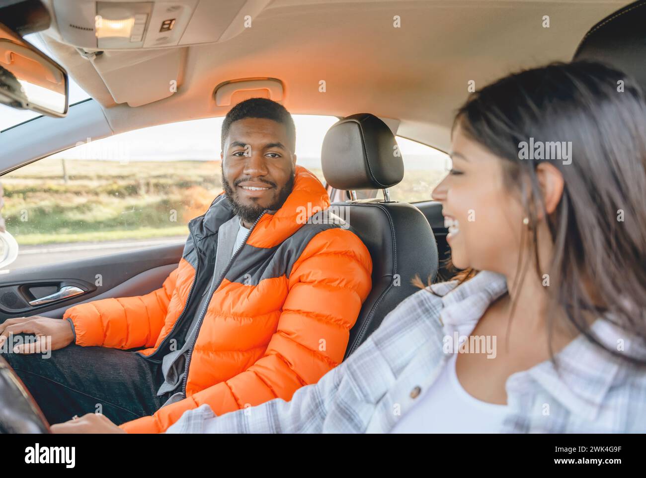 Beautiful happy young loving couple holding hands and smiling while ...