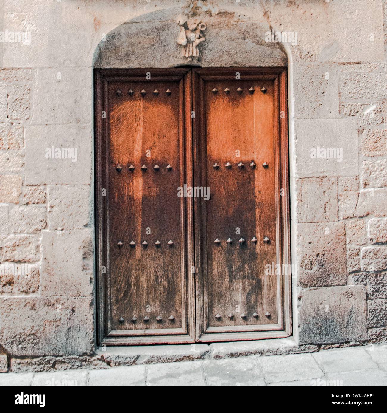 A medieval closed door with iron fittings in a stone wall. Typical ...