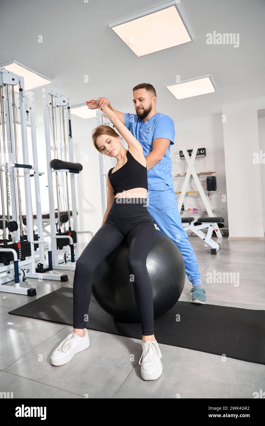 Woman performs muscle stretching exercises with a fitball Stock Photo ...