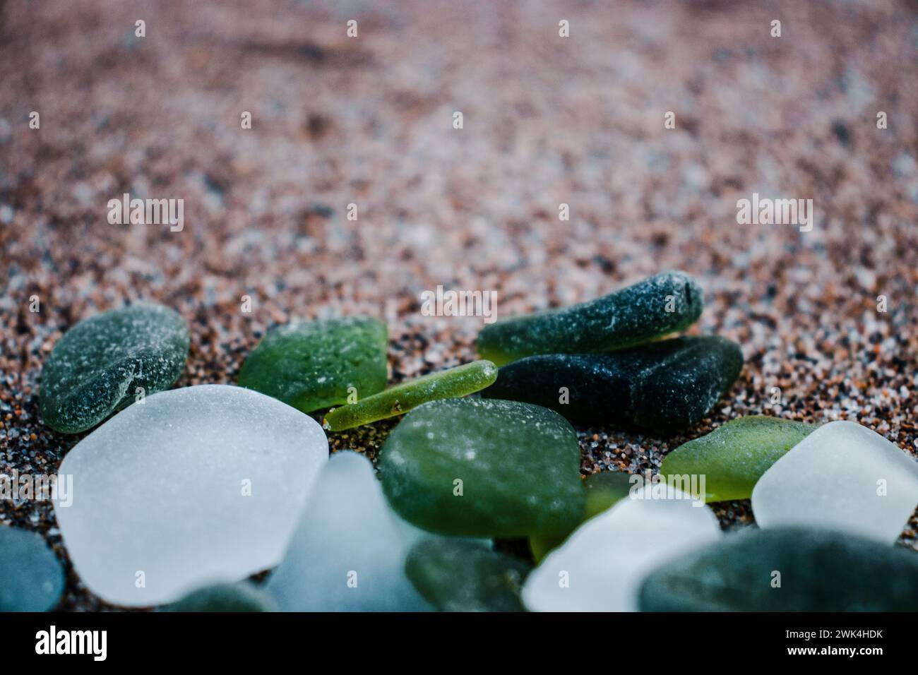 Sand beach and glass stones concept photo. Glass stones from broken ...
