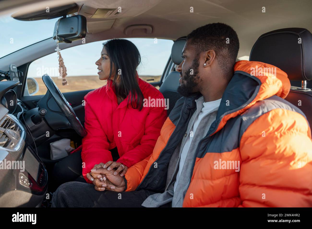 Beautiful happy young loving couple holding hands and smiling while ...