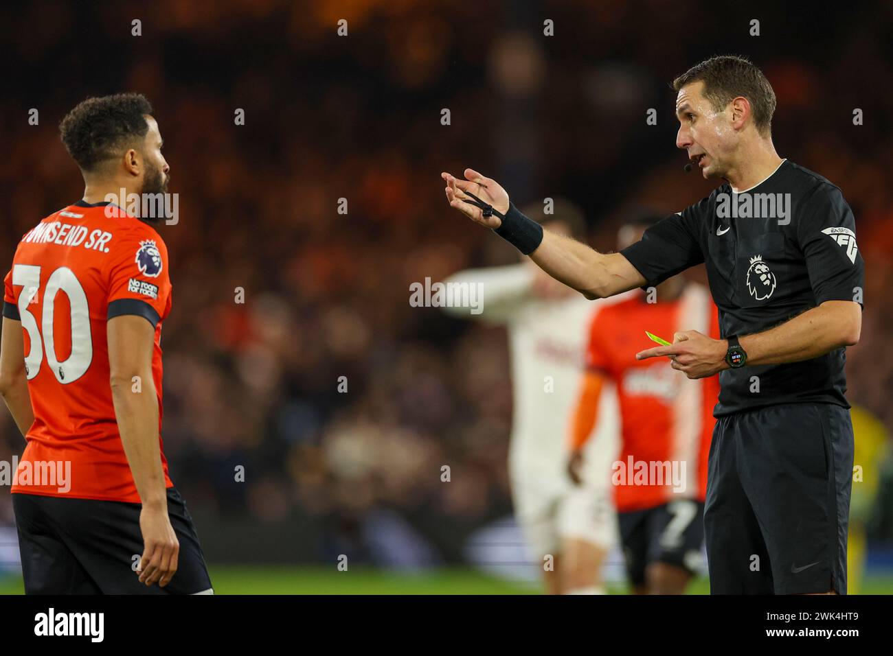 Referee David Coote, right, speaks with Luton Town's Andros Townsend ...