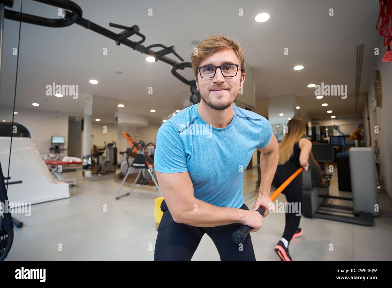 Female and male are doing a warm-up with special sticks Stock Photo - Alamy
