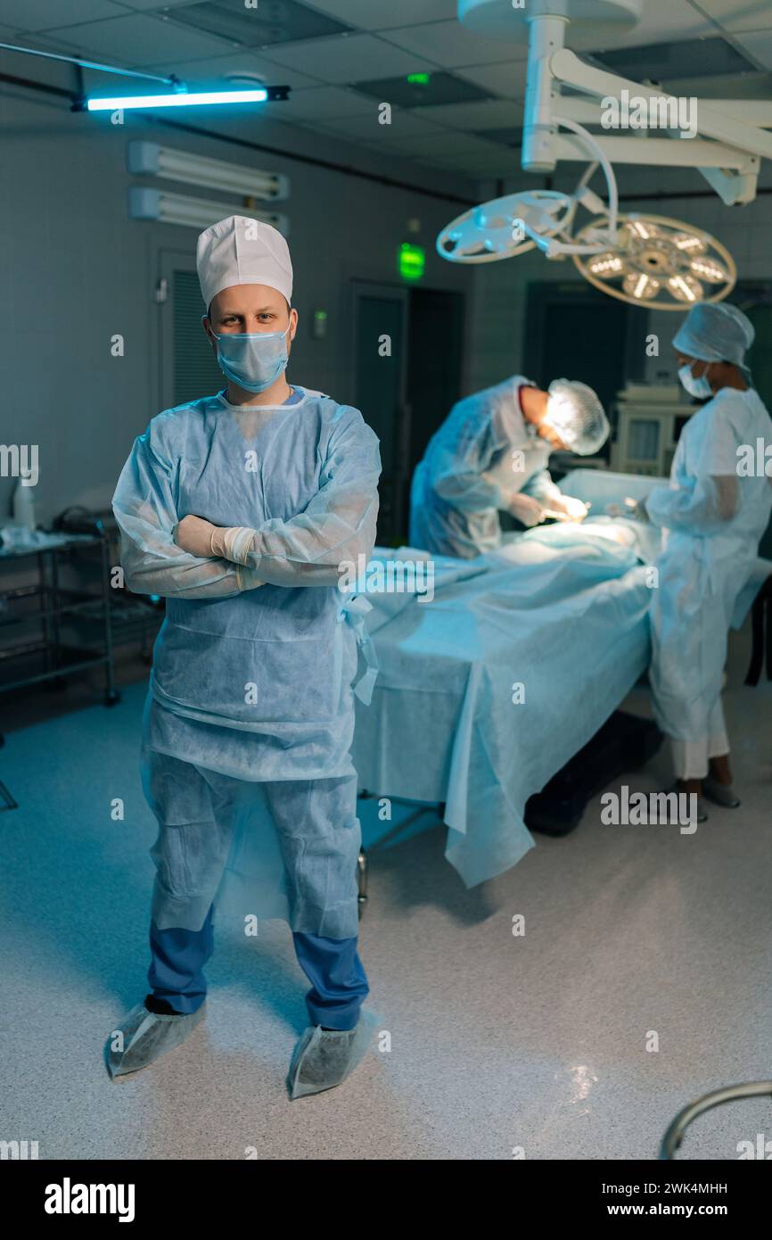 Full length vertical portrait of male doctor in surgical uniforms and ...