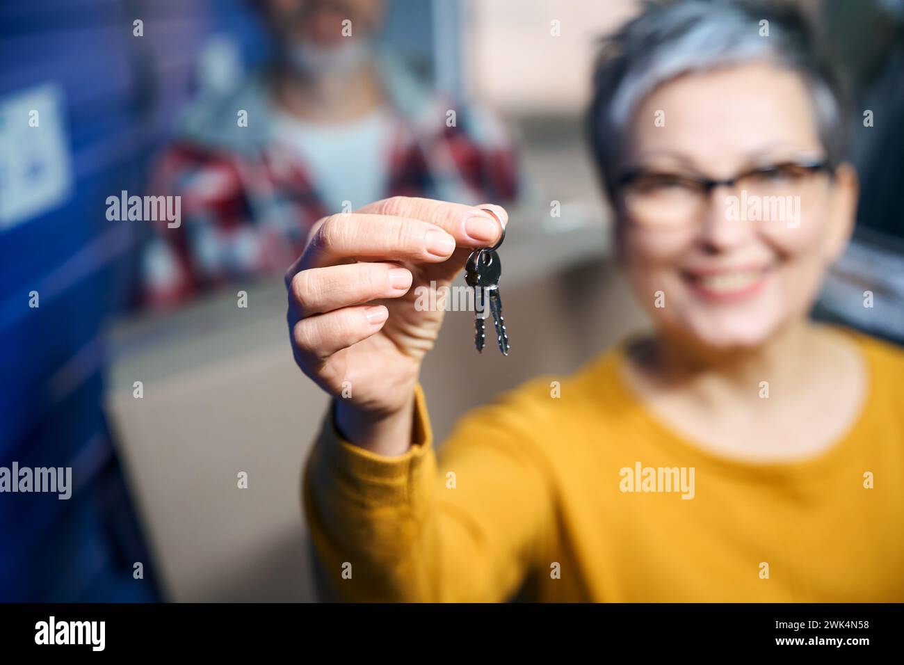 Lady holding keys in hand to storage room Stock Photo - Alamy