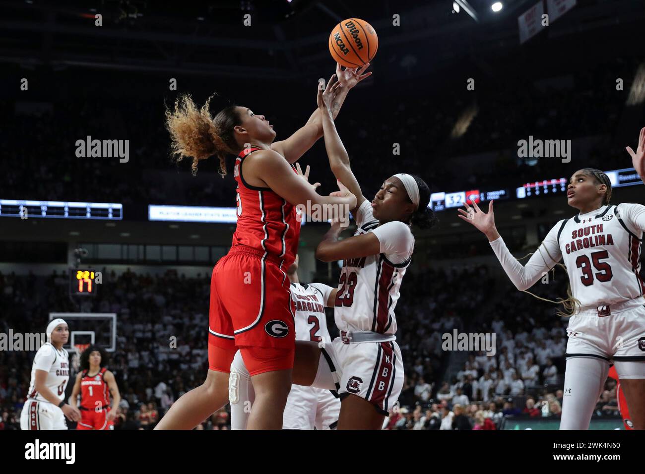 Georgia forward Javyn Nicholson, left, shoots over South Carolina guard ...