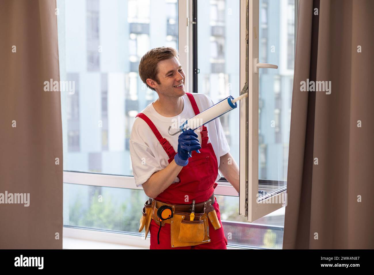 Construction worker installing window in house Stock Photo - Alamy
