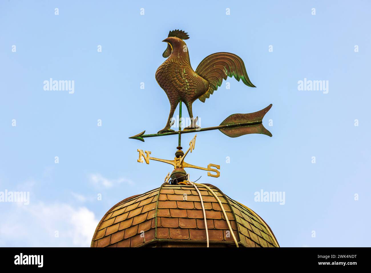Beautiful view of weather vane in the form of a metal rooster and an ...