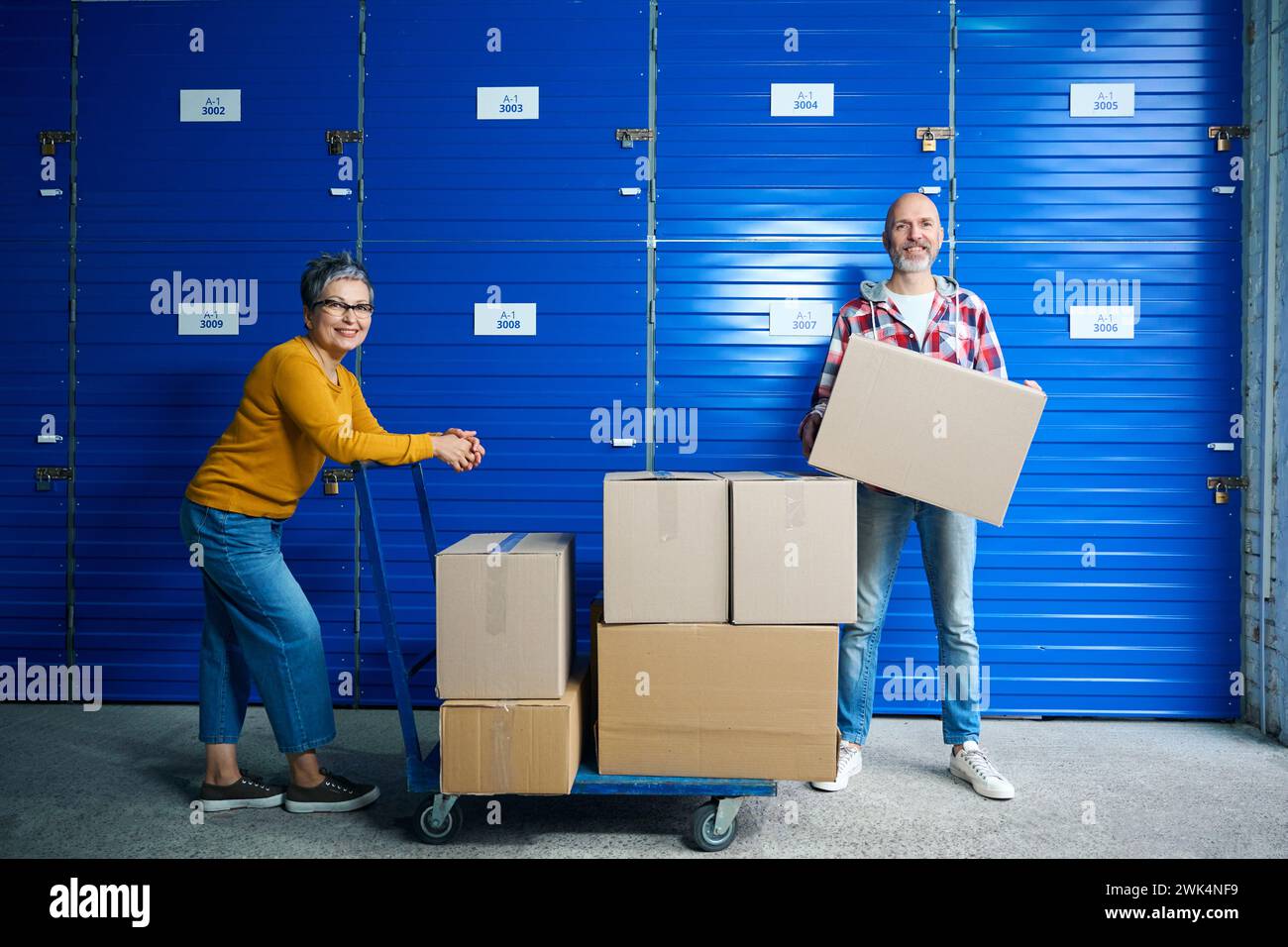 Two people standing and smiling looking at the camera Stock Photo - Alamy