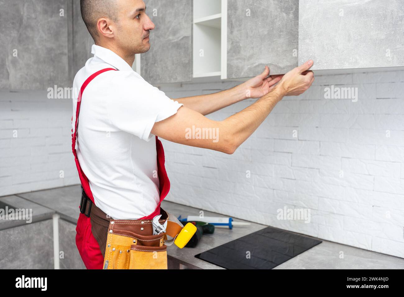 Montage of a man wallpapering Stock Photo - Alamy