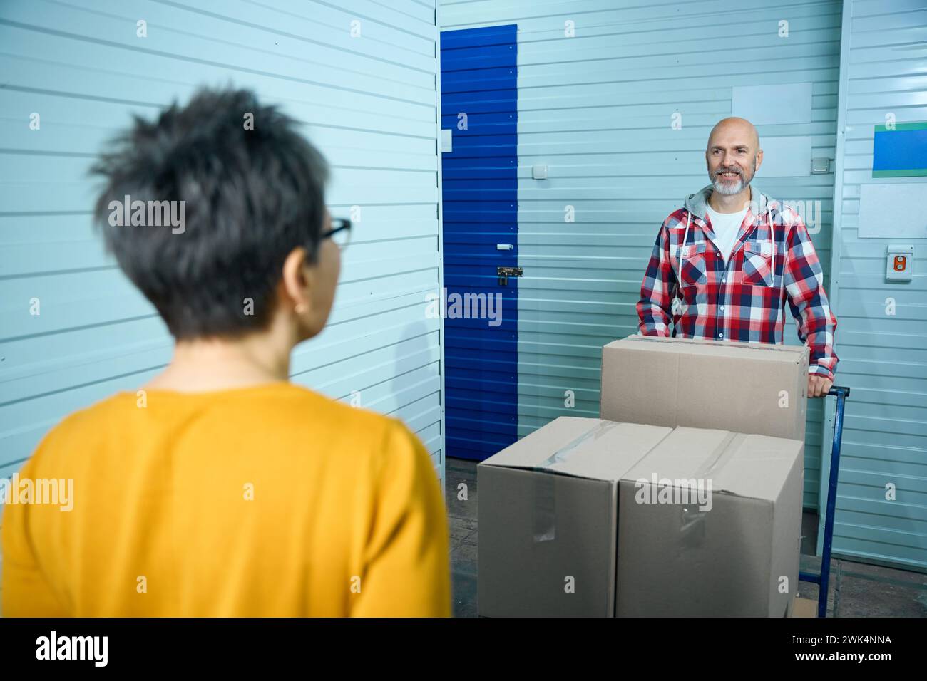 Two people in the hallway of a storage hangar Stock Photo - Alamy