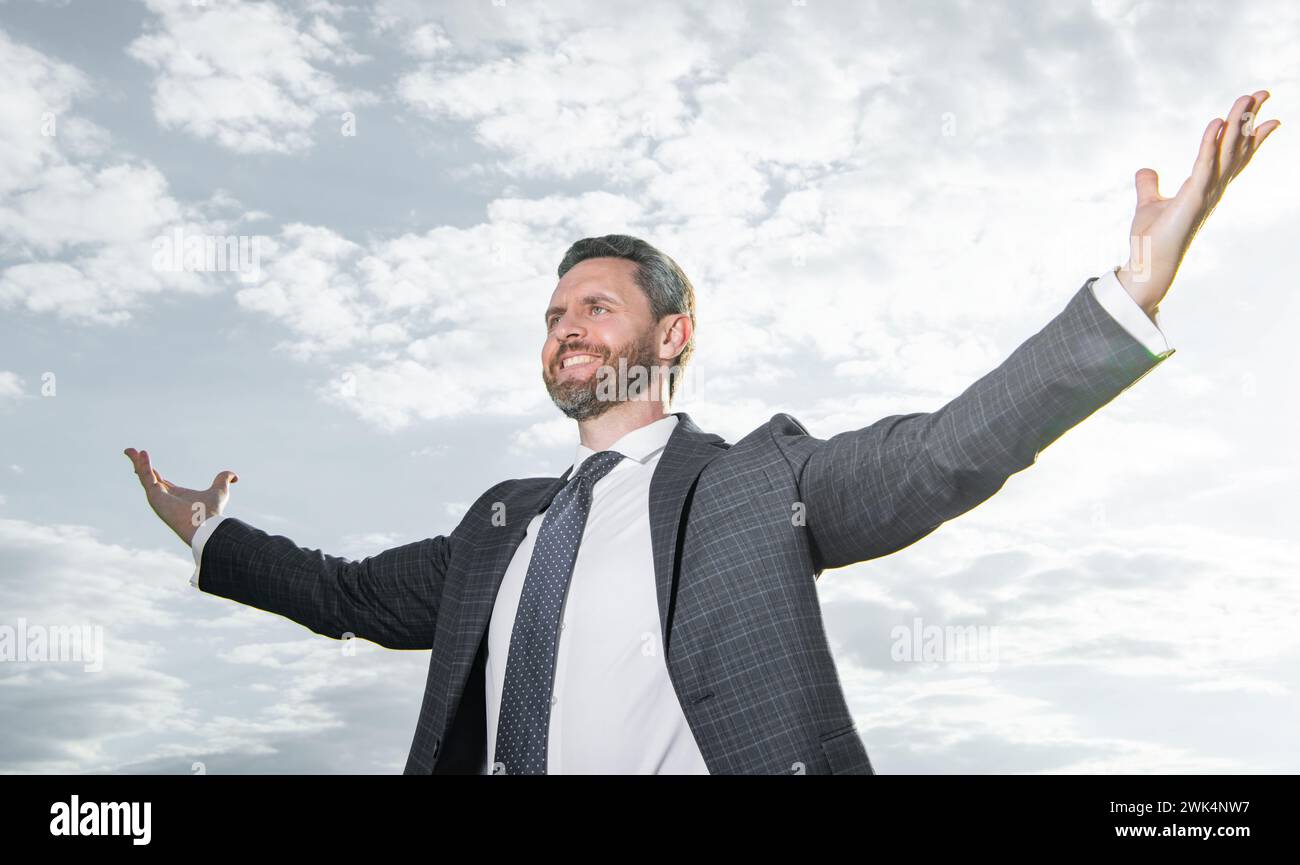 Happy man spreading arms wide open. Professional man sky background ...