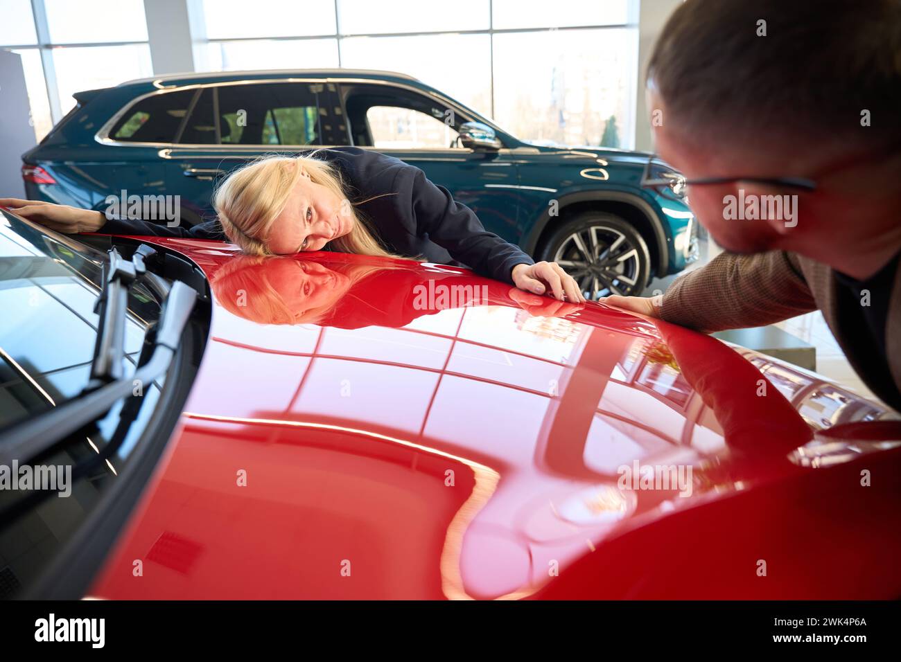 Woman hugs her purchased new red car Stock Photo - Alamy