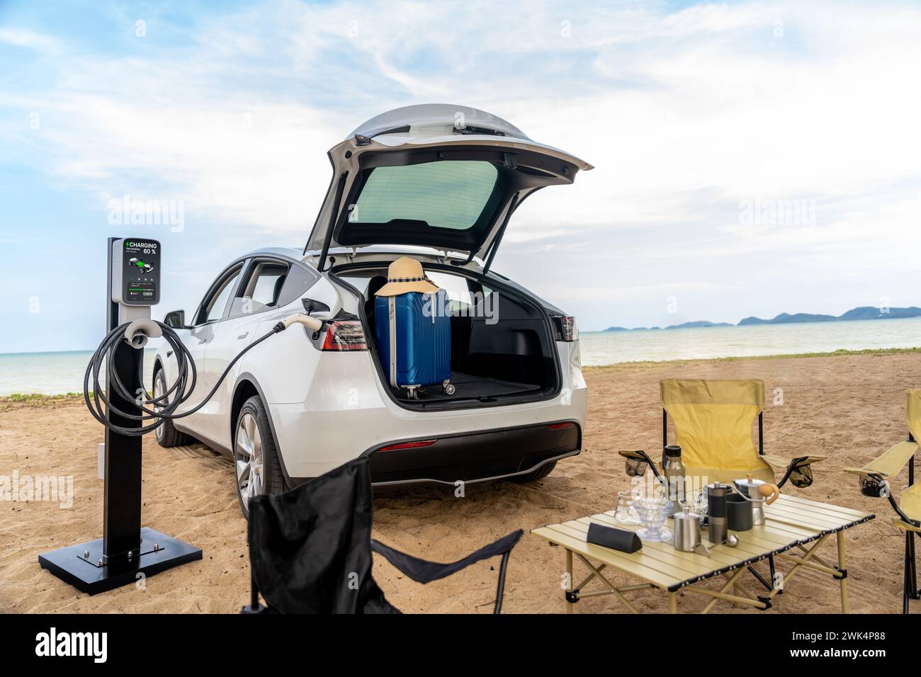 Road trip vacation traveling to the beach with electric car recharging ...