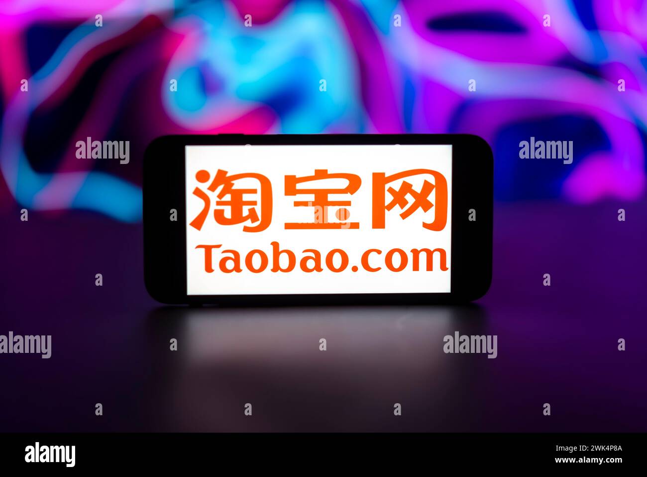In this photo illustration, the Taobao logo is seen displayed on a mobile phone screen Stock ...