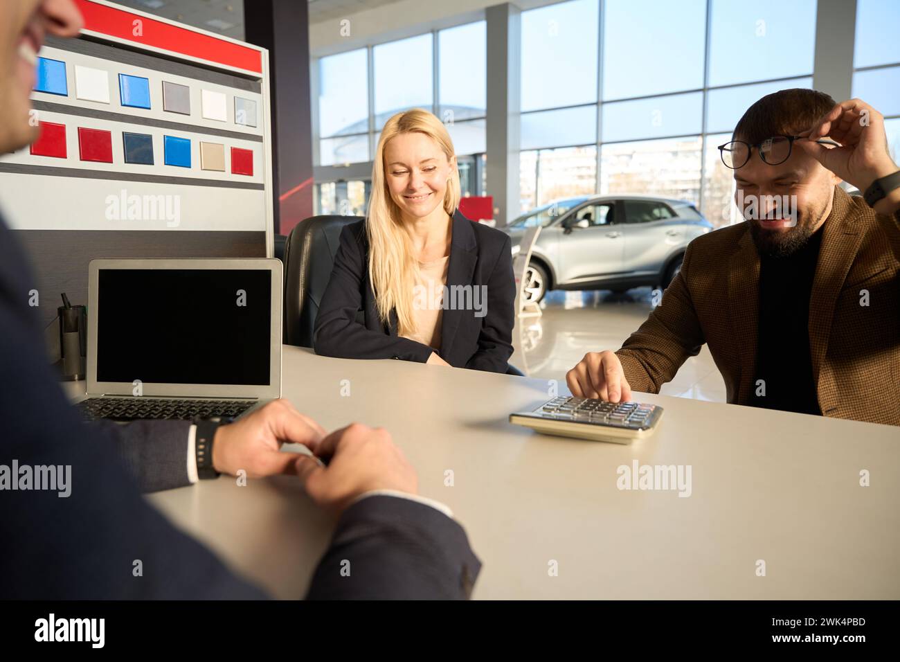 Three people sitting at a table and counting Stock Photo - Alamy