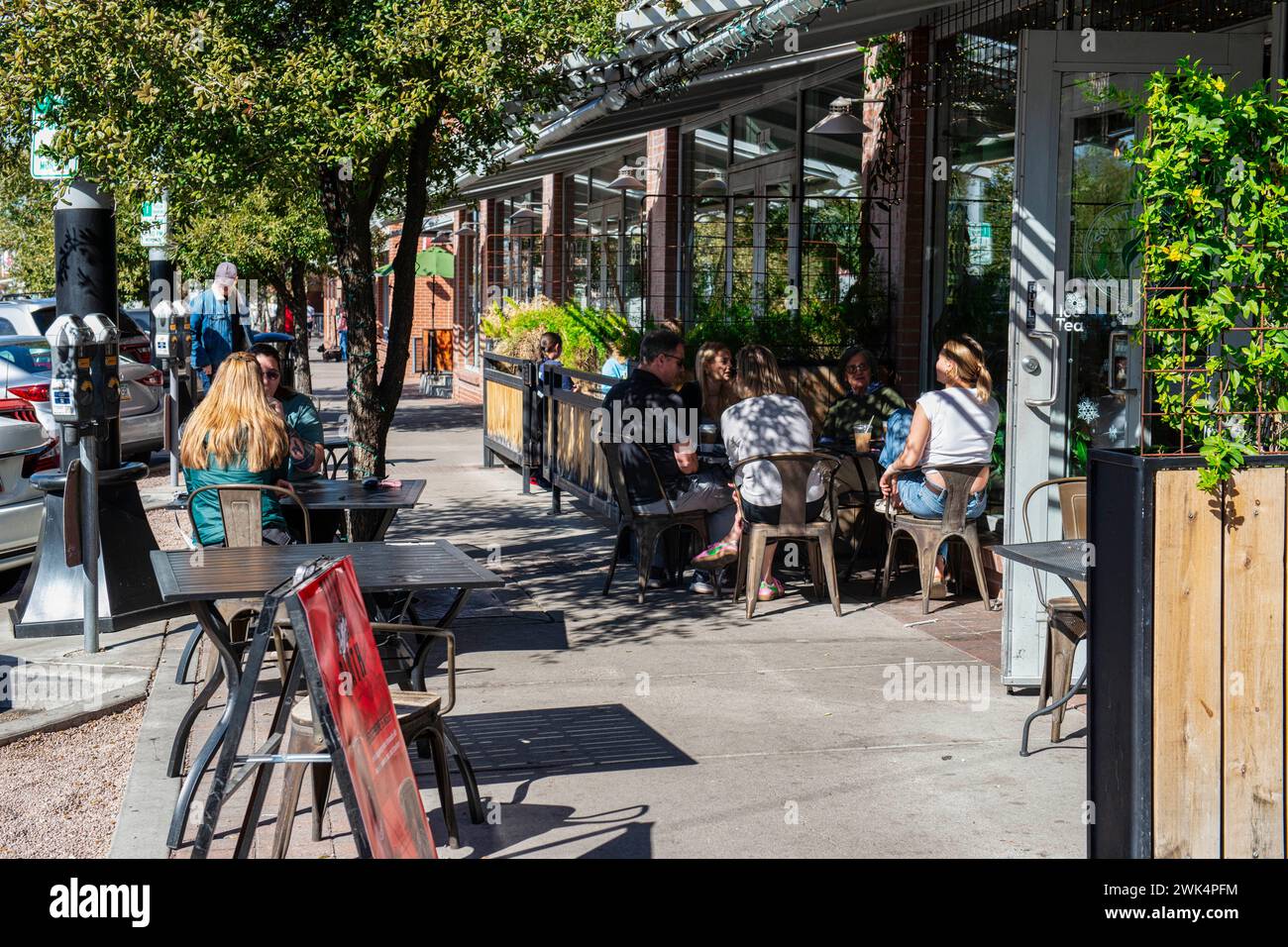 People sitting outside cafes in February along the University Blvd in ...