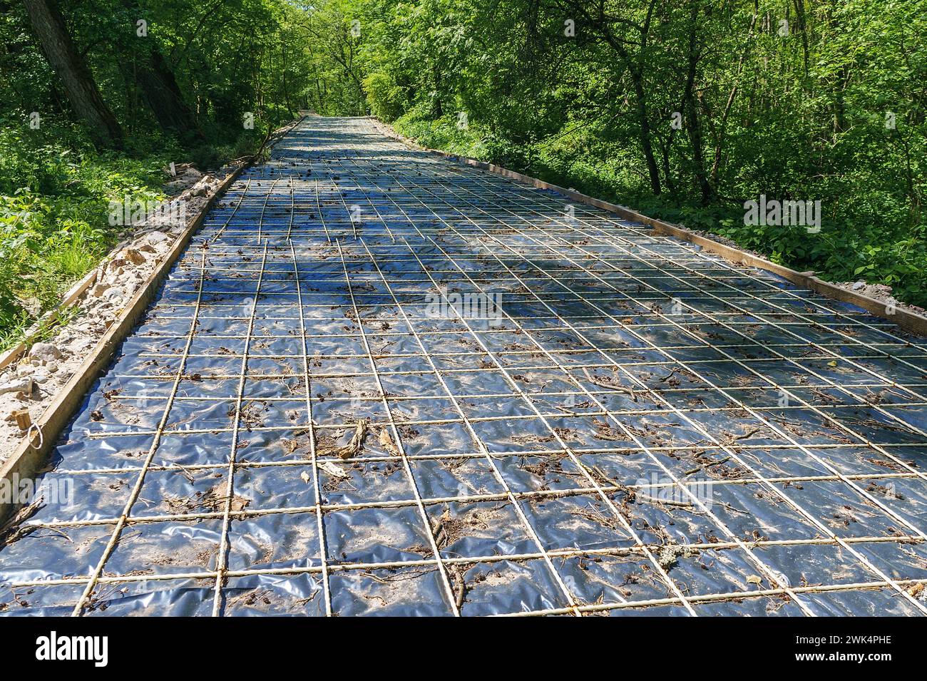 Construction of bicycle paths. Creating a sidewalk in the forest ...