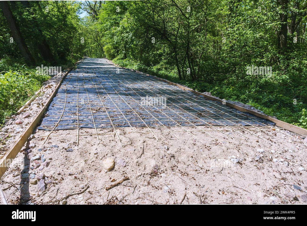 Construction of bicycle paths. Creating a sidewalk in the forest ...
