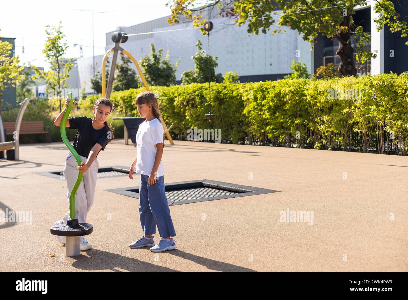 Two children spining on carousel and laughing loudly, hanging out ...