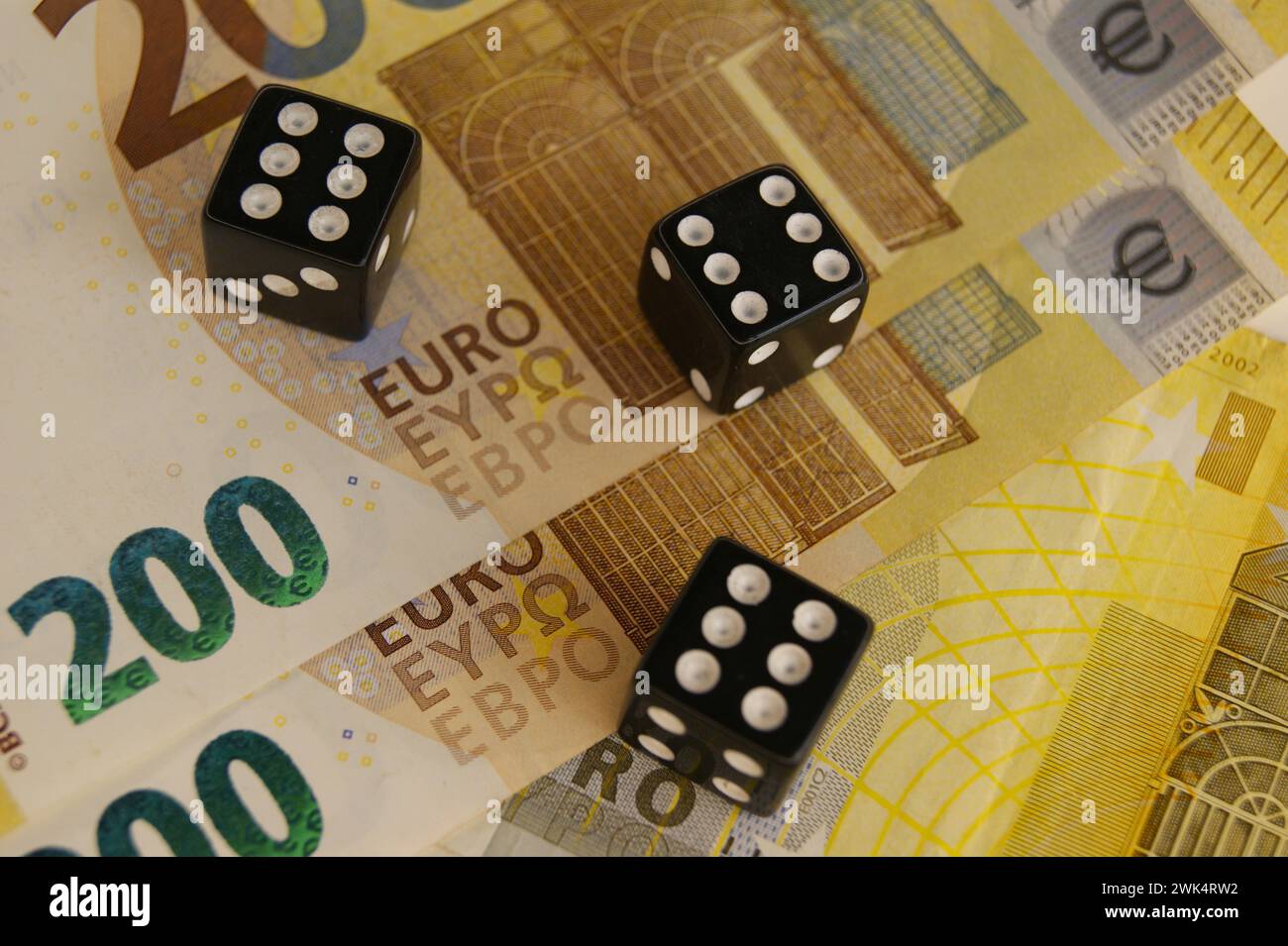 Three dice on new 200 euro banknotes Stock Photo - Alamy