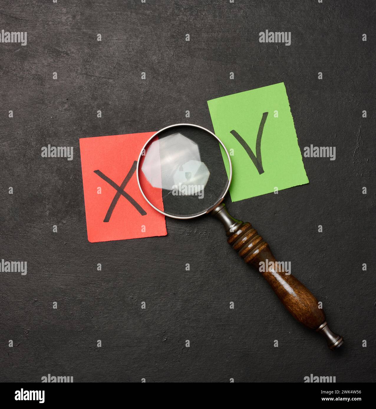 Two paper sheets with drawn check mark and cross symbols, representing ...