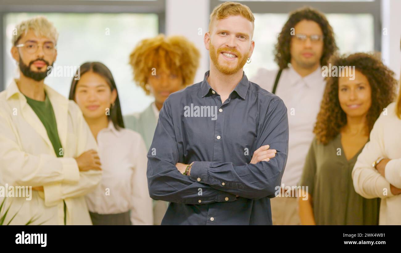 Man standing proud leading a teamwork in the office Stock Photo - Alamy