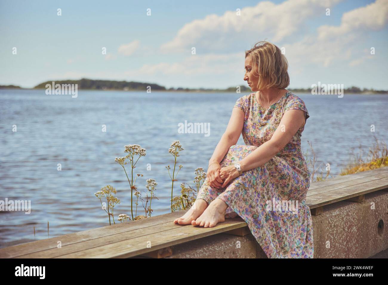 Aalborg, Denmark, July 10, 2022: mature woman relaxing near the sea ...