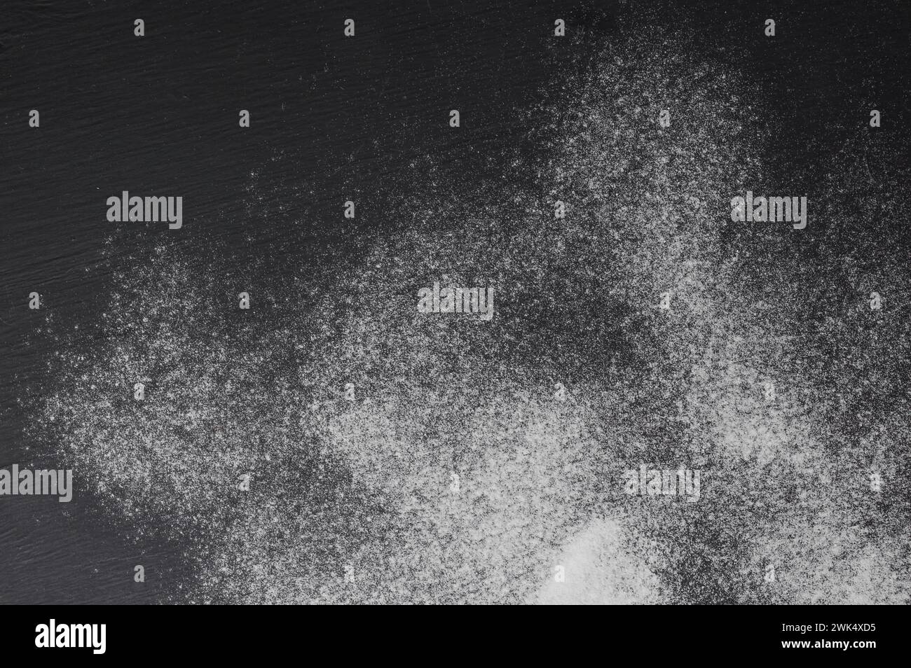 flour scattered on a black background. Background for baking and flour ...