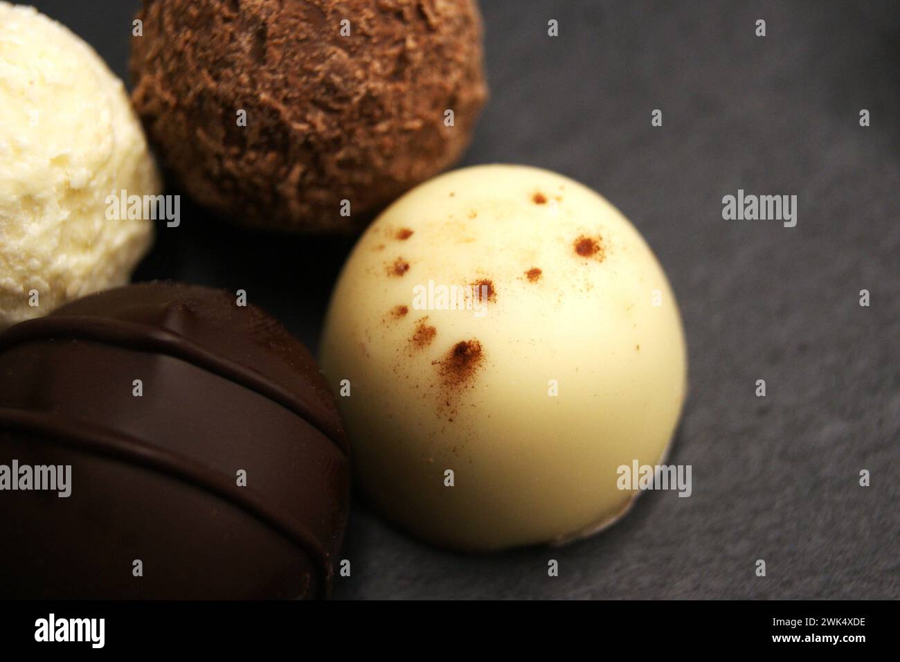 Various chocolate candies on a dark background Stock Photo - Alamy