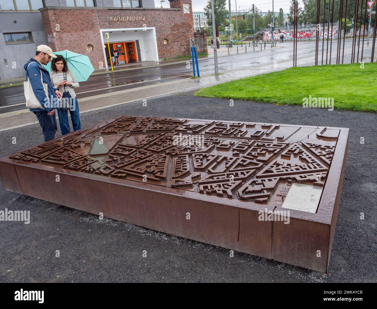 Visitors looking at the scale model showing the Berlin Wall Memorial ...