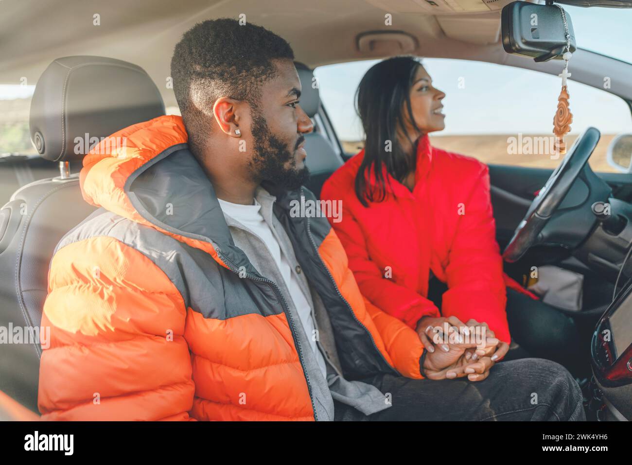 Beautiful happy young loving couple holding hands and smiling while ...