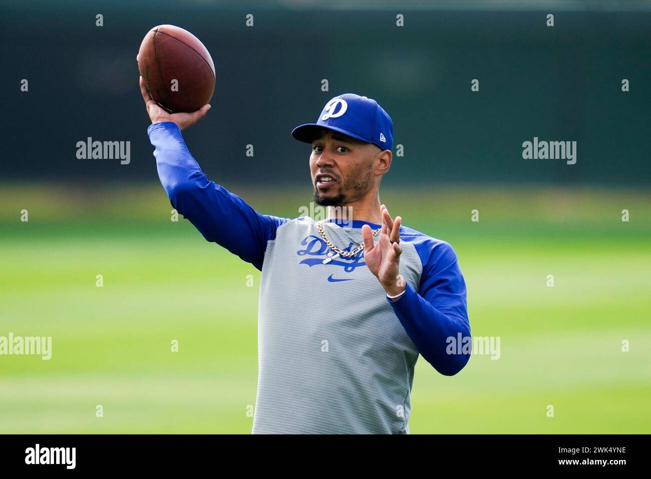 Los Angeles Dodgers right fielder Mookie Betts throws a football during ...