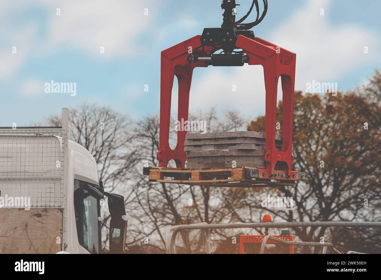 Construction materials delivered on site and being offloaded by ...