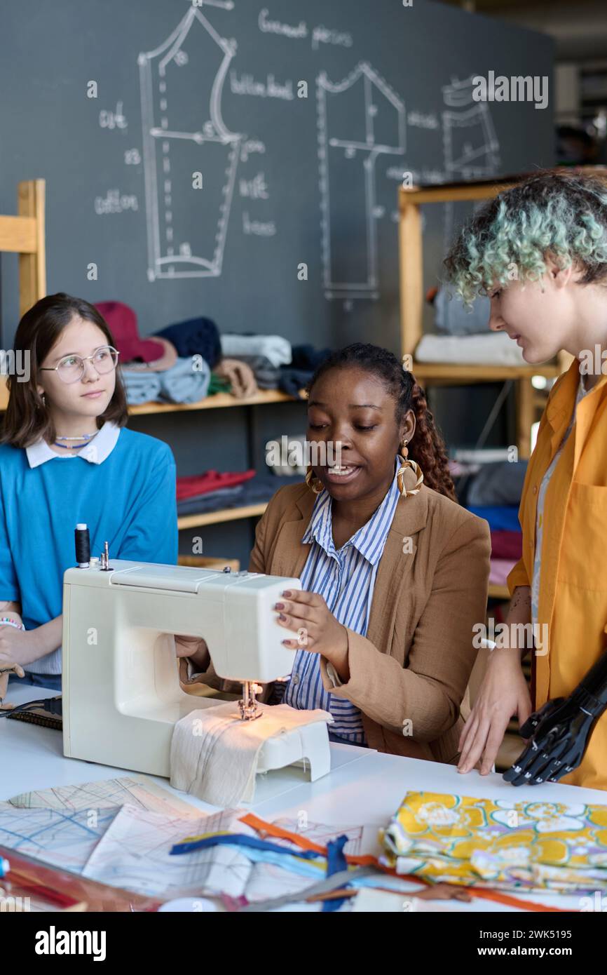 Vertical portrait of African American woman mentoring girls with ...