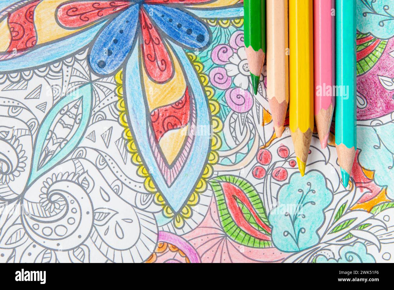 Colored pencils on a artistic mandala design, top view, mindfulness and ...