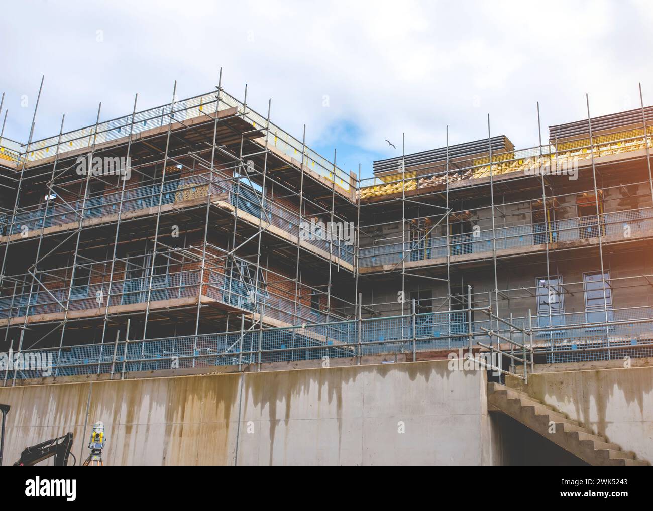 Scaffolds erected around a new multistorey brick house on a new ...