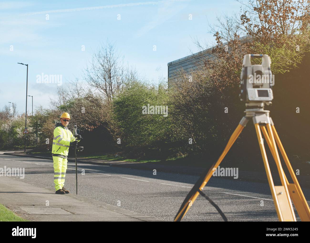 Surveyor doing road survey using modern robotic total station EDM ...