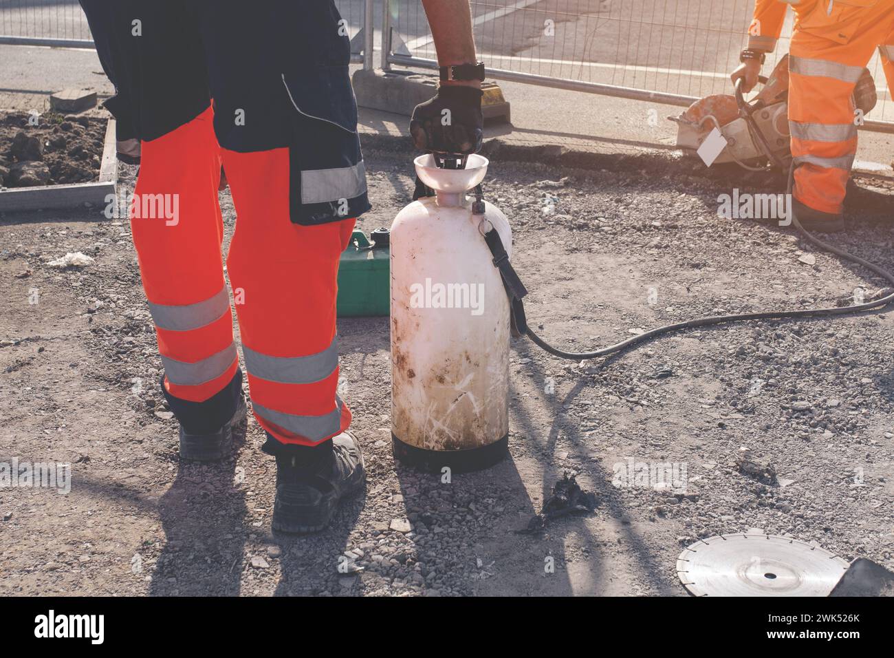 Groundworker cutting asphalt with petrol saw Stock Photo - Alamy