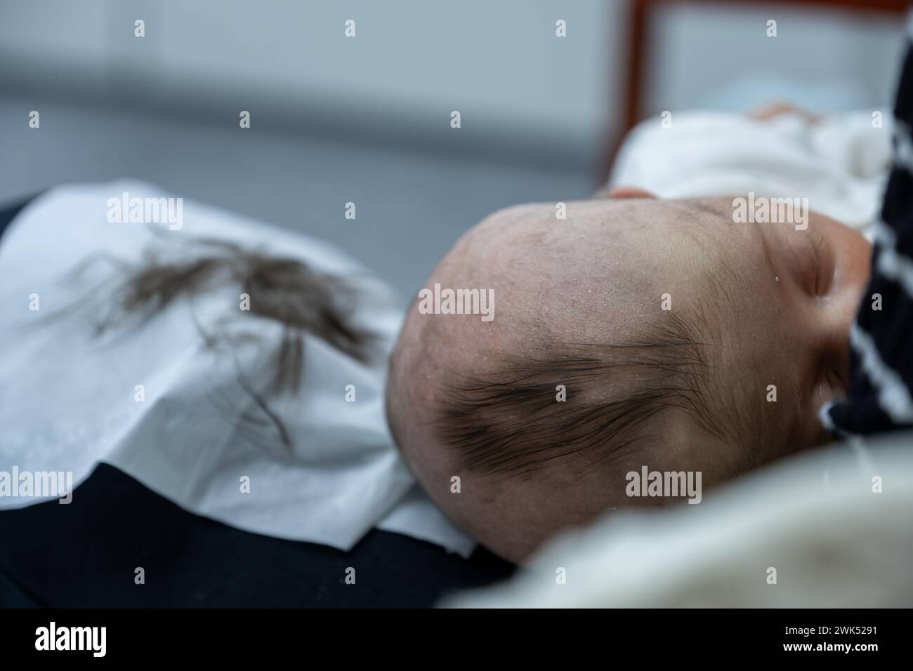 baby girl shaving her hair with sharp razor. shaving hair for 1 month ...