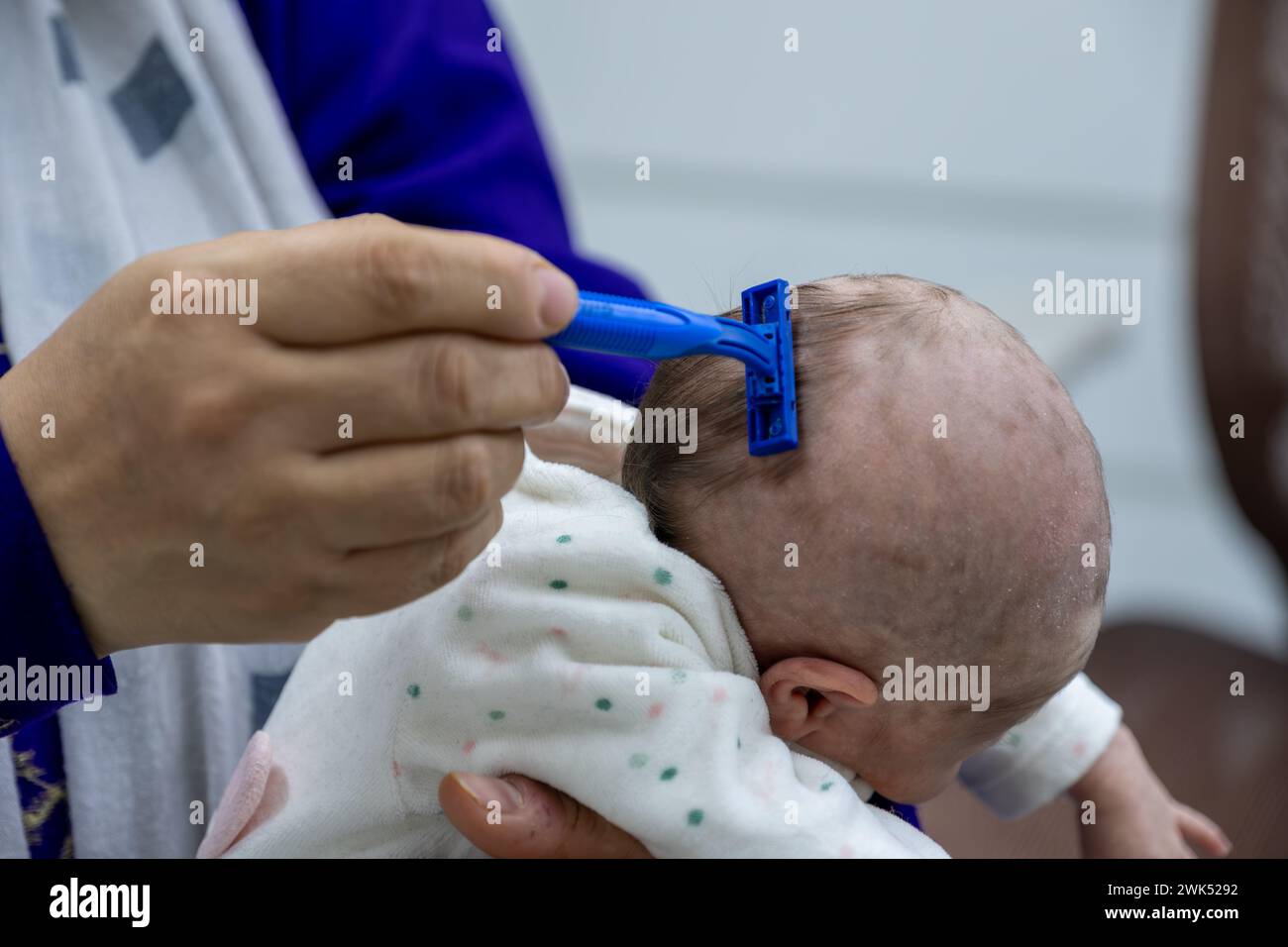baby girl shaving her hair with sharp razor. shaving hair for 1 month ...
