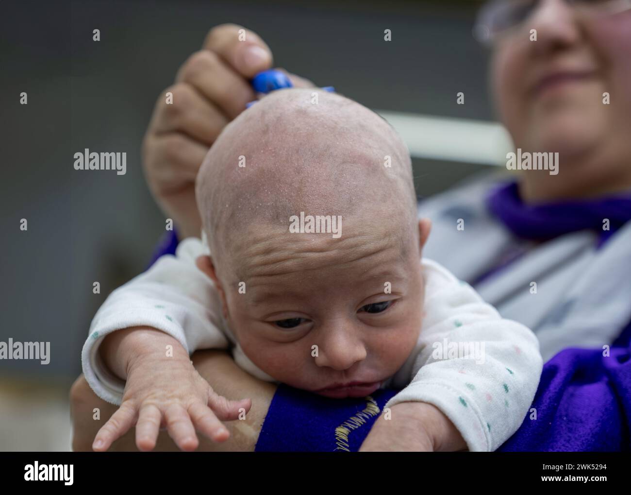 baby girl shaving her hair with sharp razor. shaving hair for 1 month ...