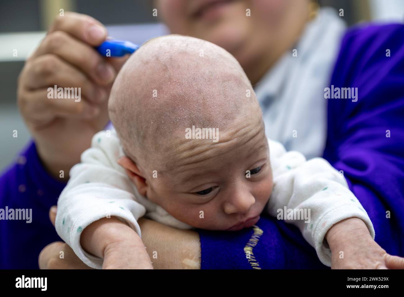 baby girl shaving her hair with sharp razor. shaving hair for 1 month ...