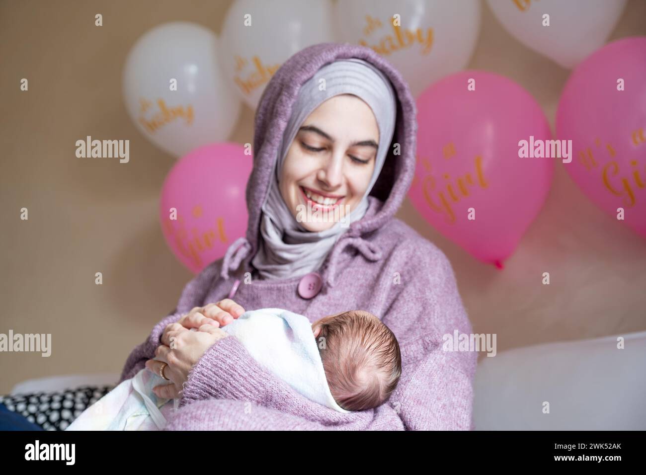 mother holding her new born in her hand and feeling love him for her ...