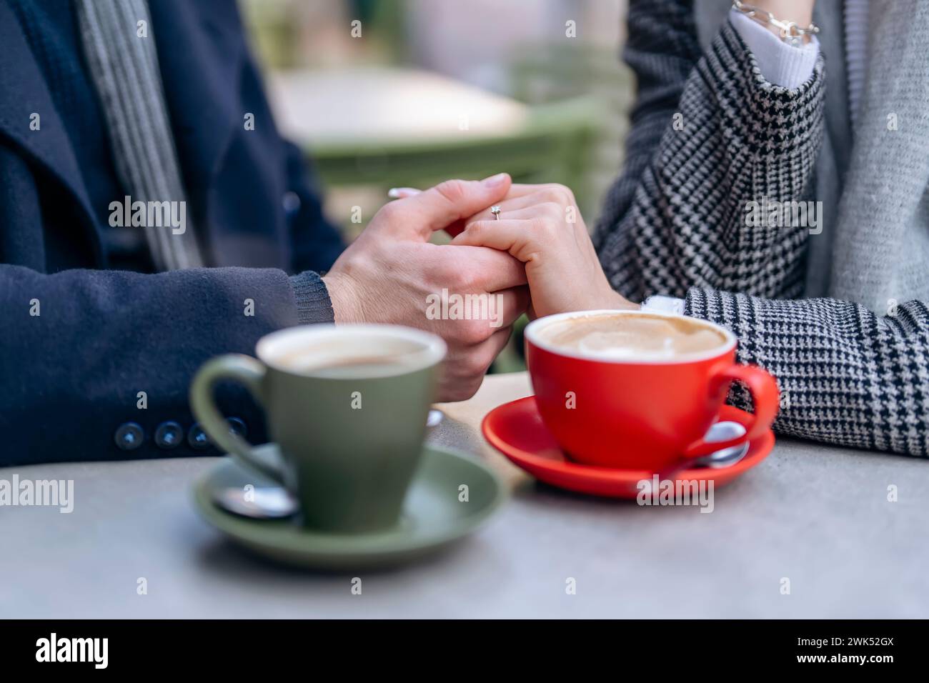 Handsome man and beautiful woman hugging each other as they walk around ...